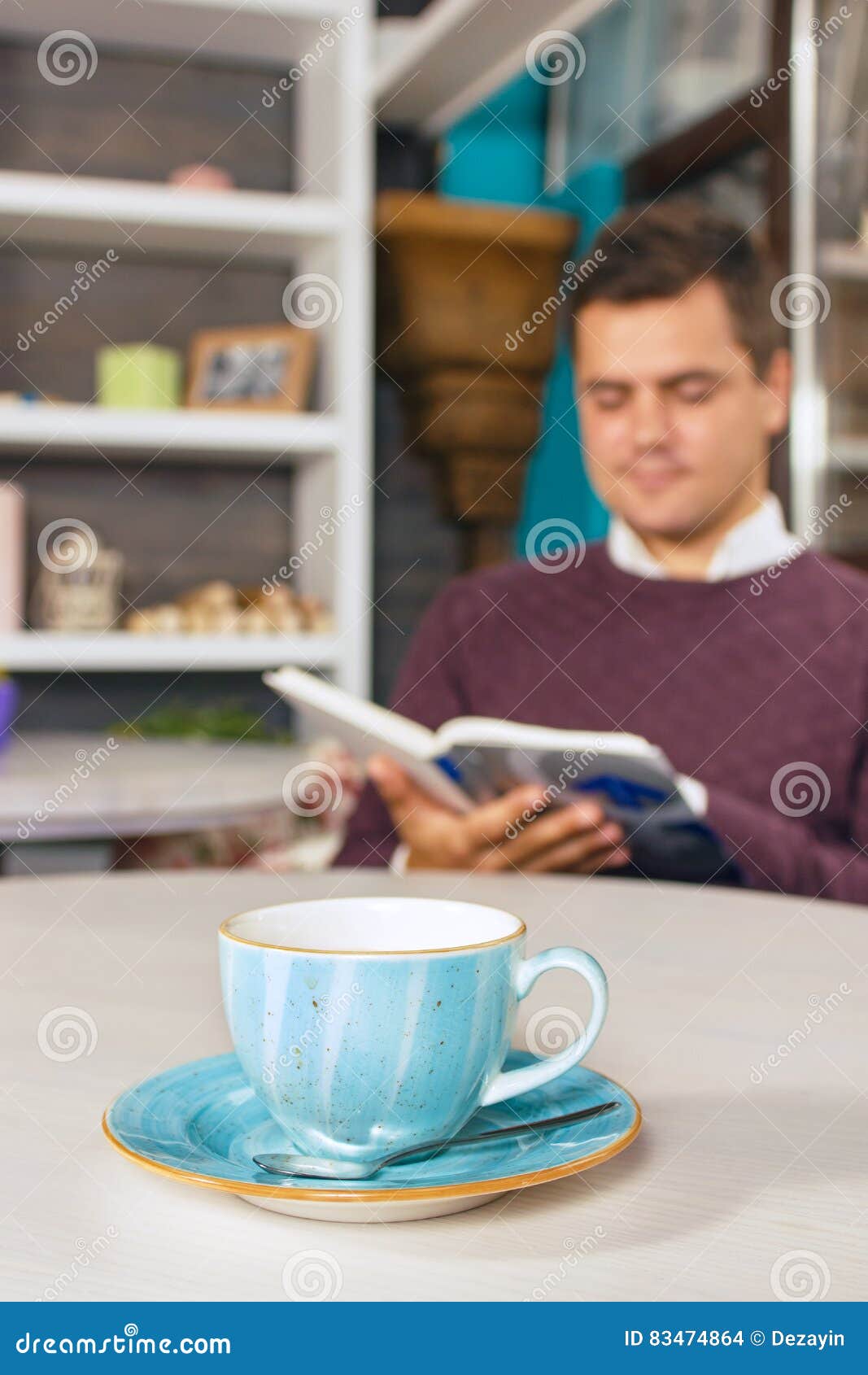 Young Man Sitting in Cafe and Reading a Book Stock Photo - Image of ...