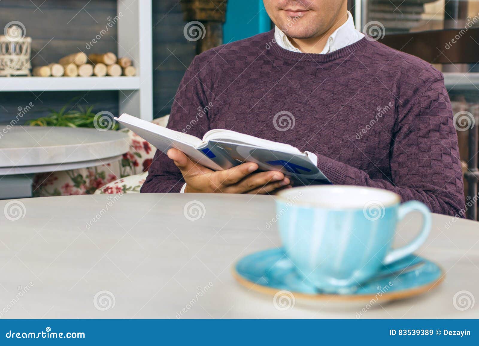 Young Man Sitting in Cafe and Reading a Book Stock Image - Image of ...