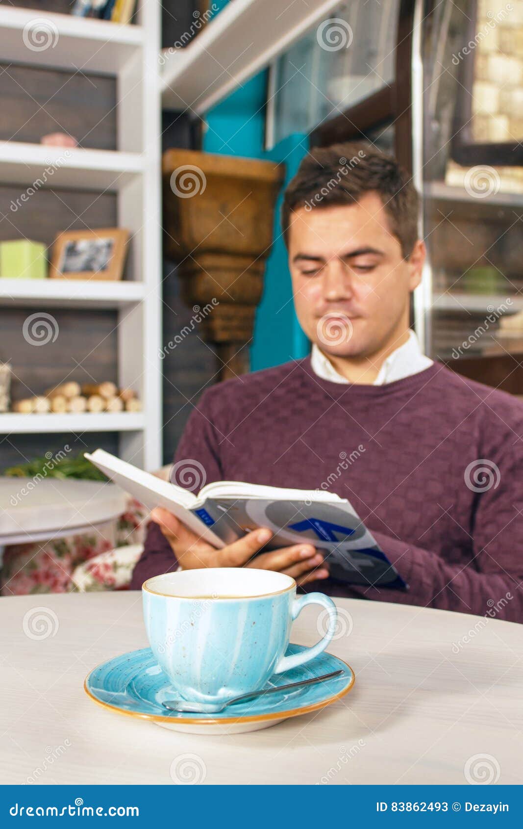 Young Man Sitting in Cafe and Reading a Book Stock Image - Image of ...