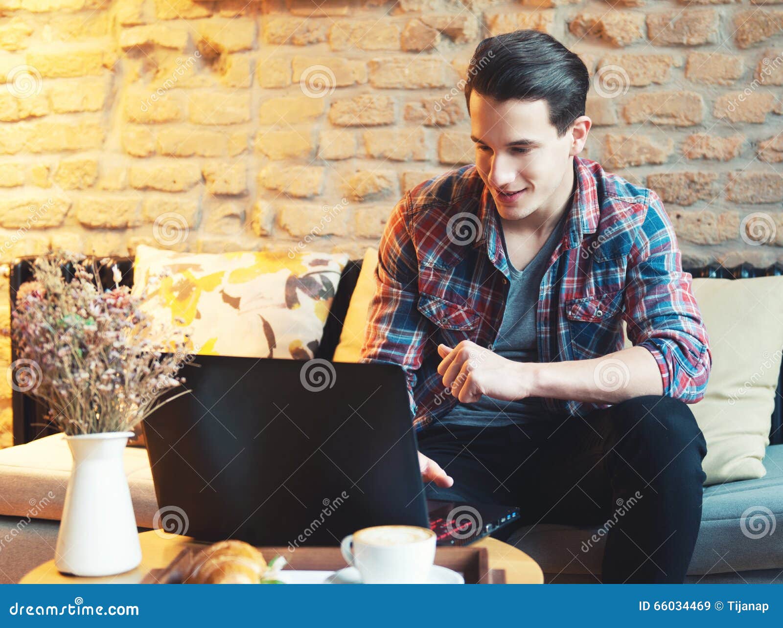 Young Man Sitting at a Cafe, Using a Laptop Stock Image - Image of ...