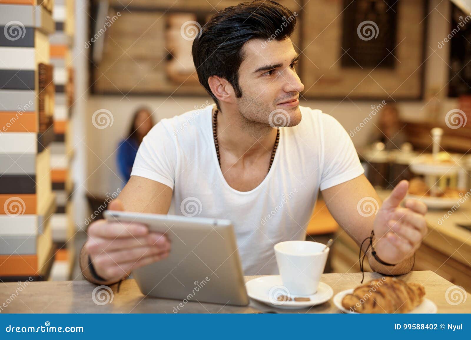 Young man sitting in cafe stock photo. Image of alone - 99588402
