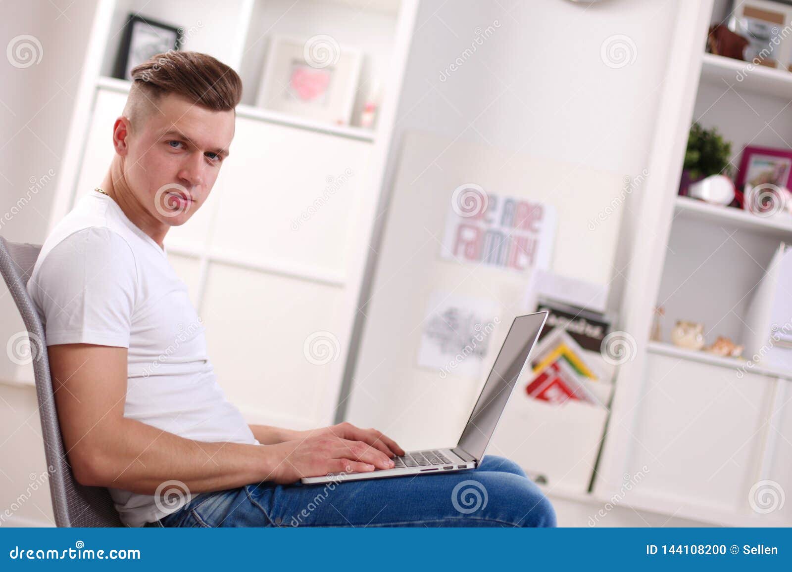 Young Man Sitting on Chair with Laptop Stock Photo - Image of caucasian ...