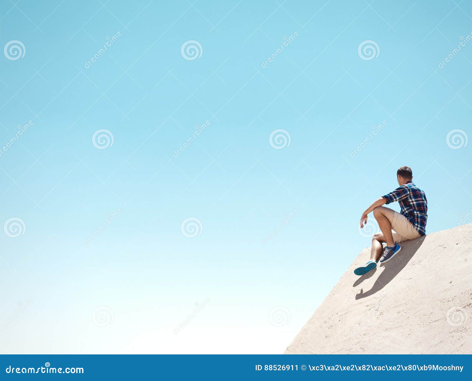 Young Man Sitting on a Cliff Stock Image - Image of cliff, leap: 88526911