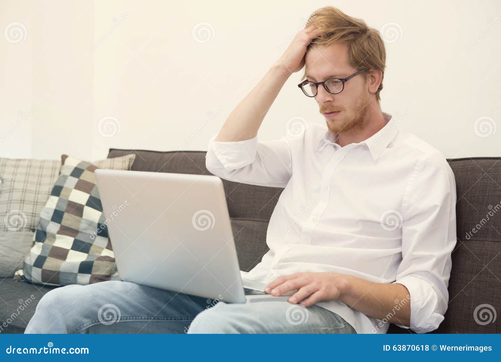 Young Man Sitting on Couch with Laptop Stock Photo - Image of leisure ...