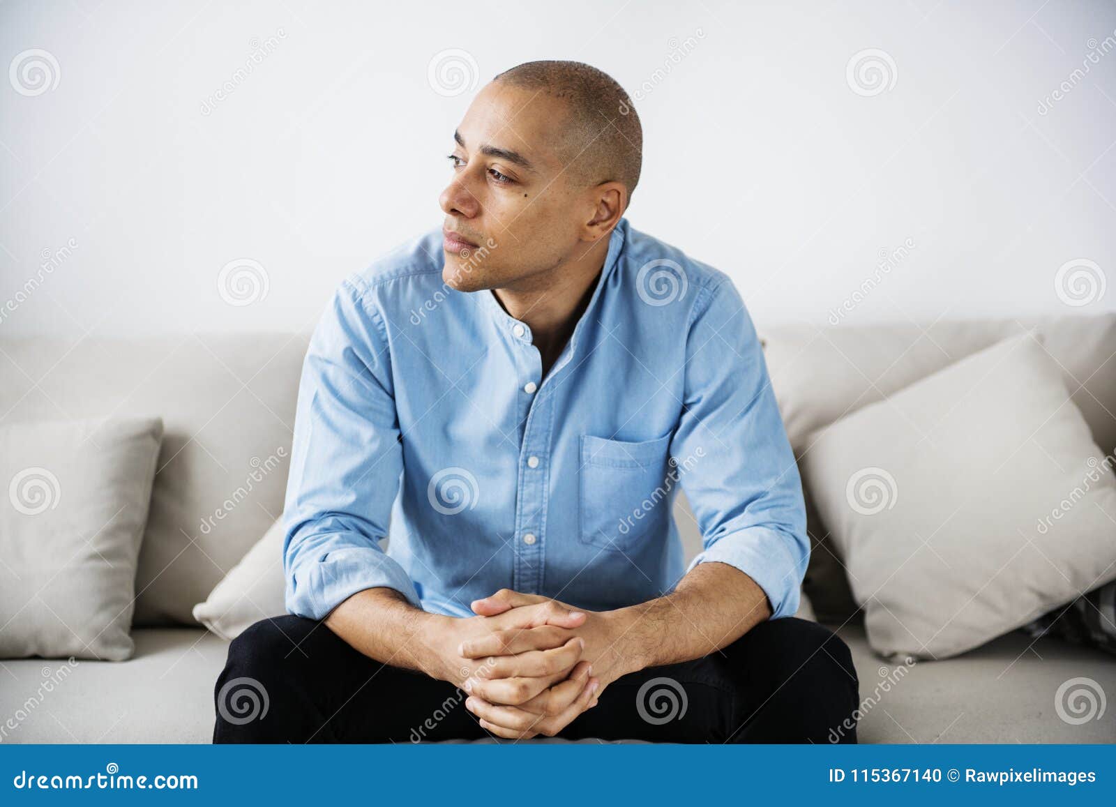 Young Man Sitting on a Couch Thinking Stock Photo - Image of formal ...