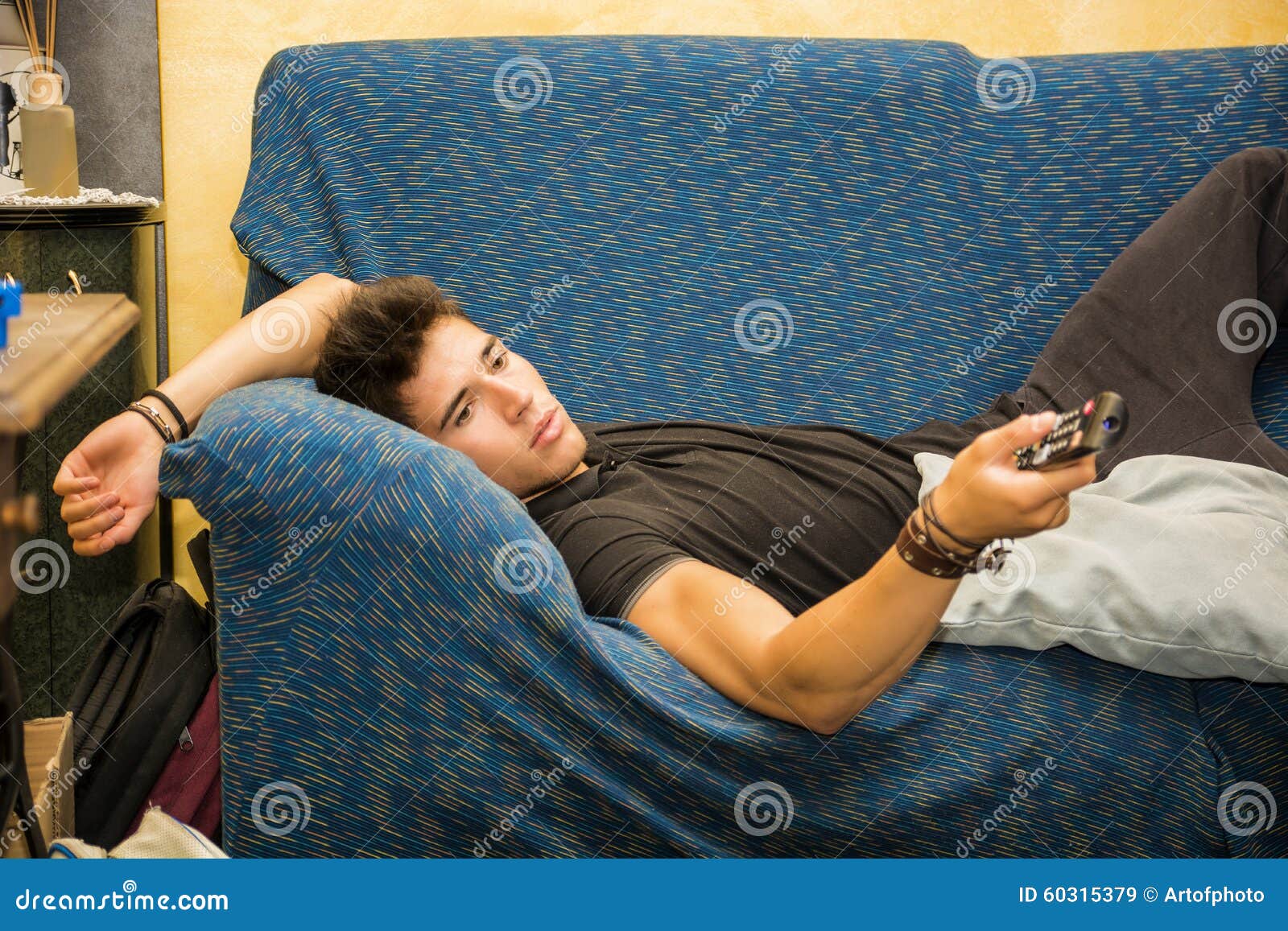 Young Man Sitting on Couch Watching Television Stock Image - Image of ...