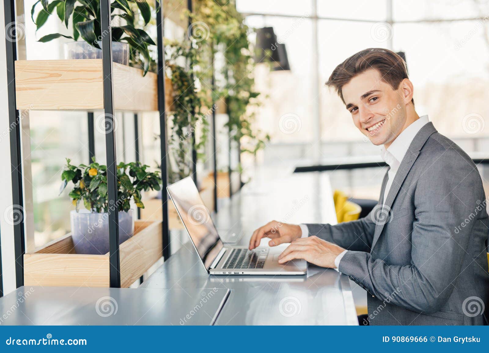 Young Man Sitting at Desk in Office, Working on Laptop Computer. Stock ...