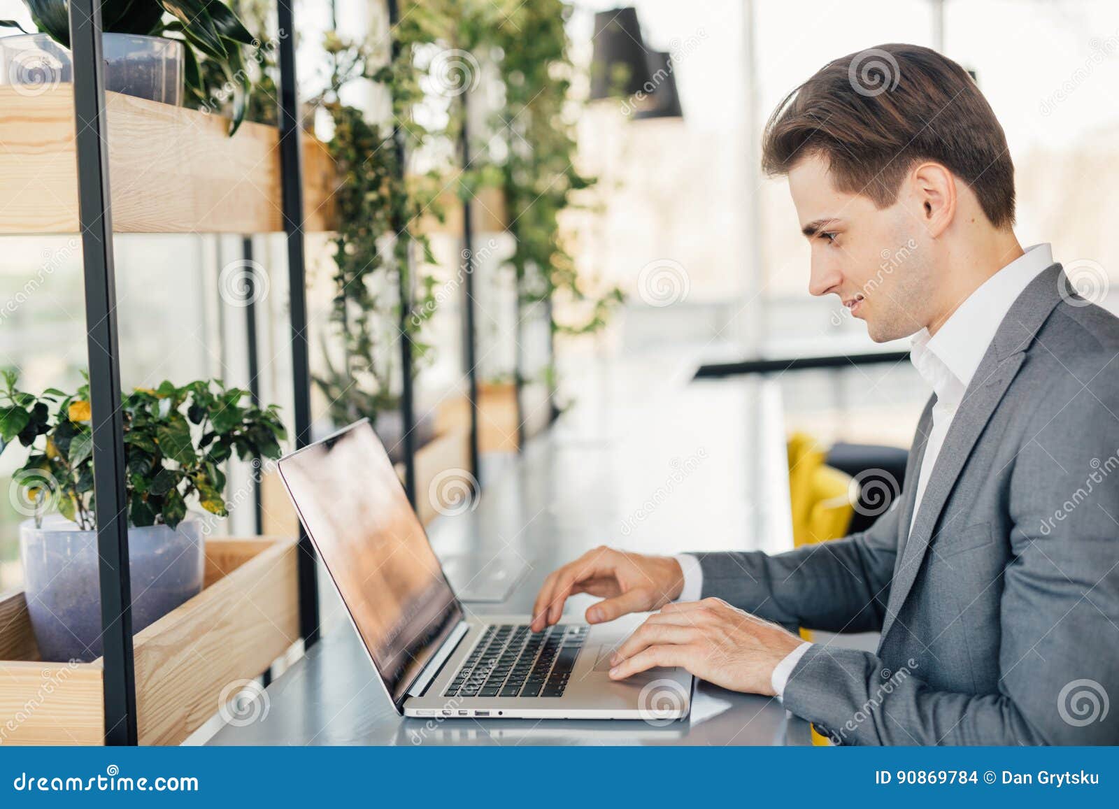 Young Man Sitting at Desk in Office, Working on Laptop Computer. Stock ...