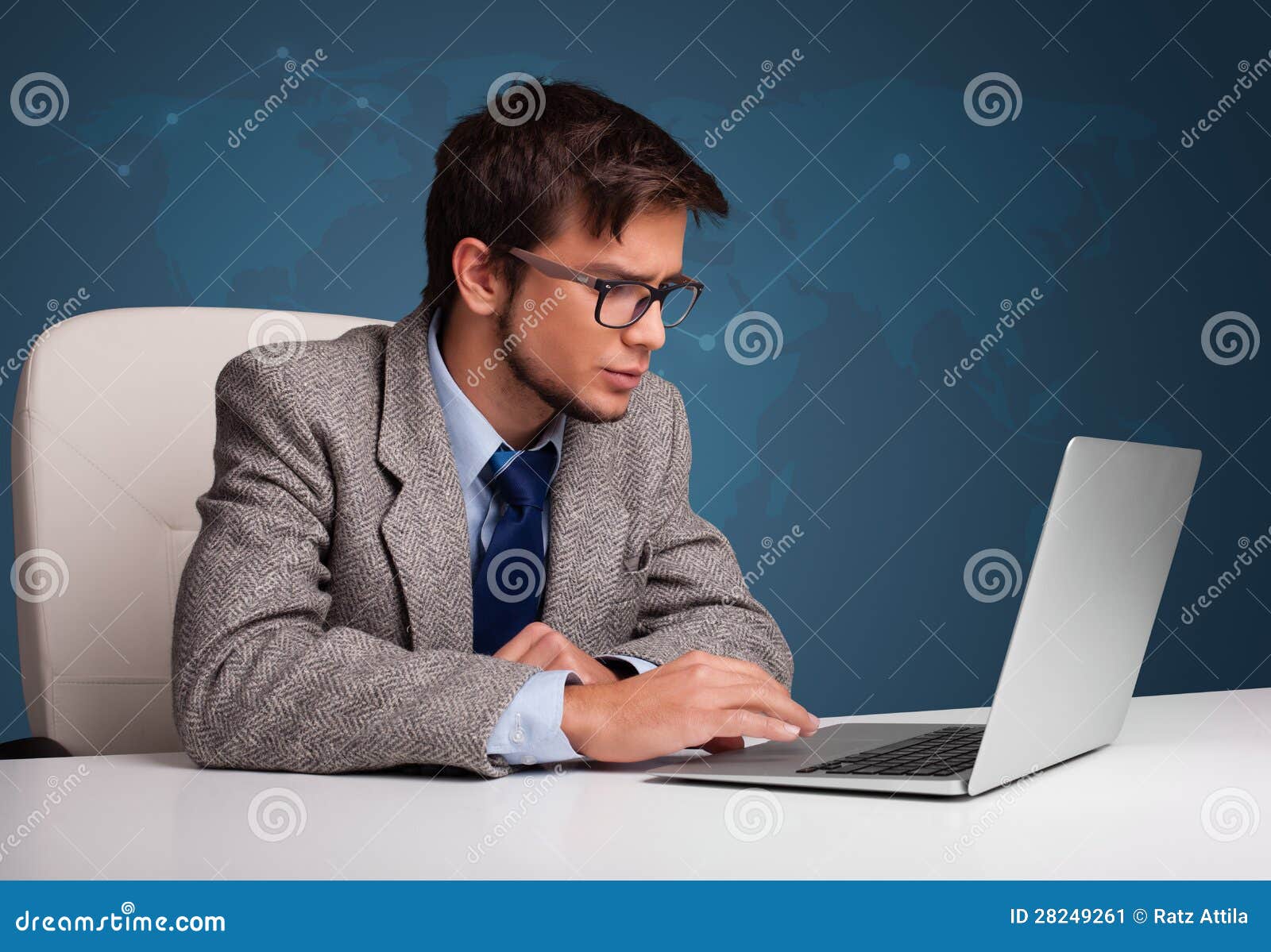 Young Man Sitting at Desk and Typing on Laptop Stock Image - Image of ...