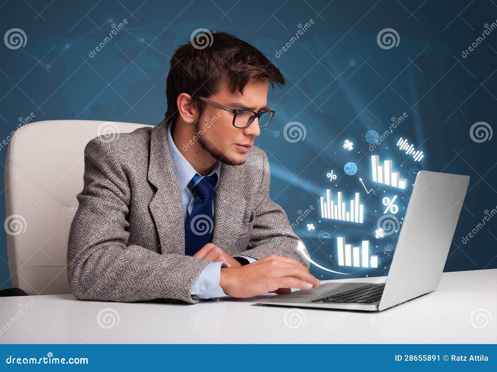 Young Man Sitting at Desk and Typing on Laptop with Diagrams and Stock ...