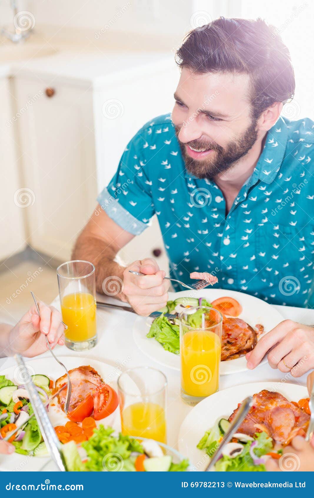 Young Man Sitting at Dining Table Smiling Stock Image - Image of ...