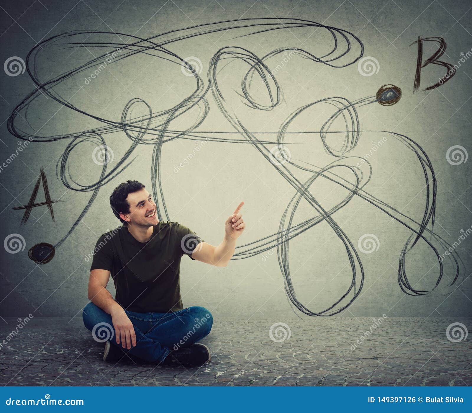 Young Man Sitting on the Floor Pointing Forefinger Finding the Correct ...