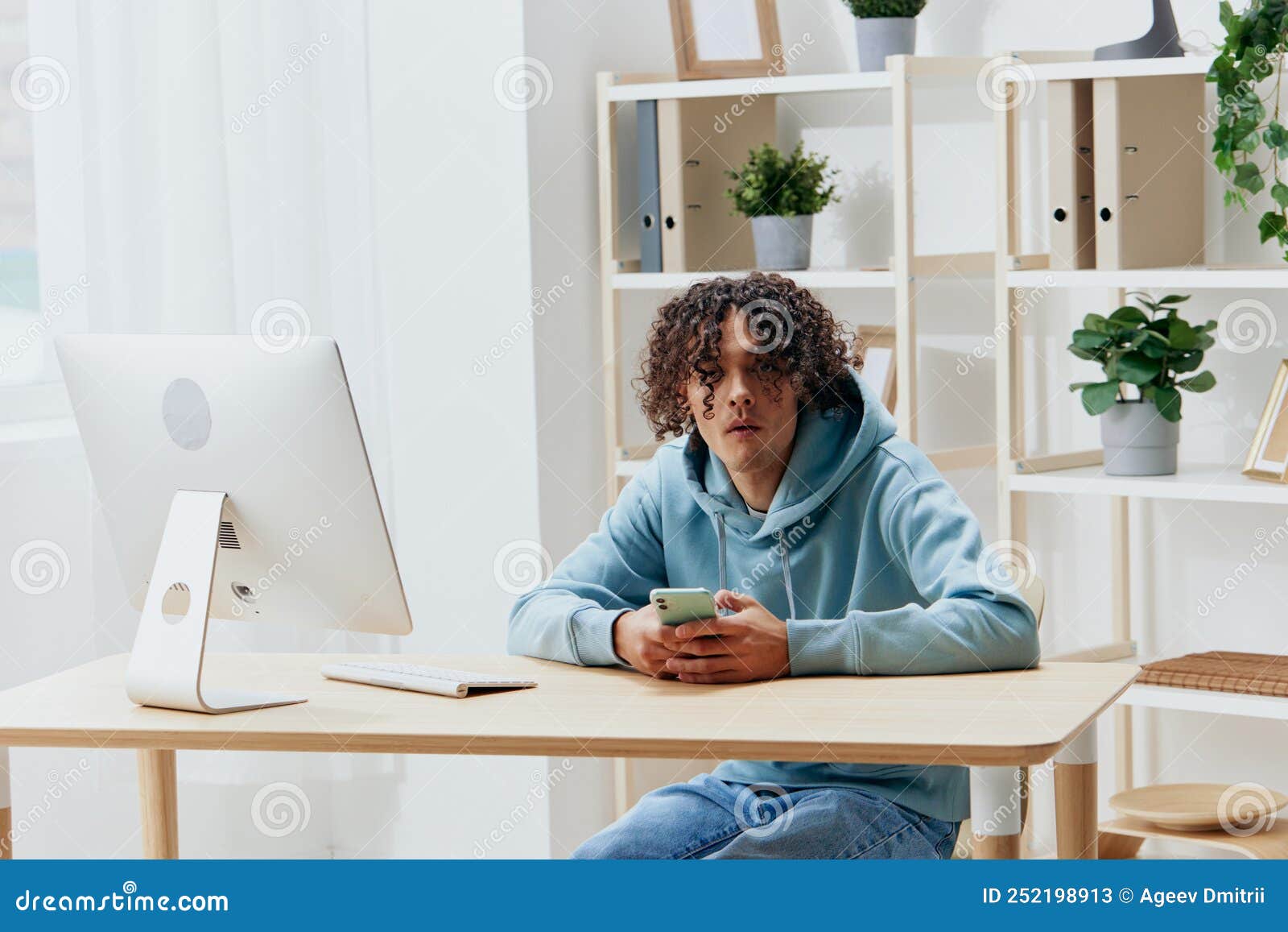 A Young Man Sitting in Front of the Computer Work at Home Technologies ...