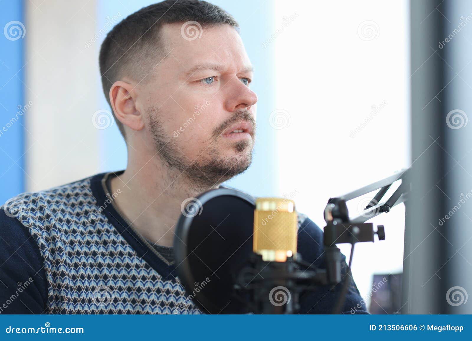Young Man Sitting in Front of Microphone in Recording Studio Stock ...