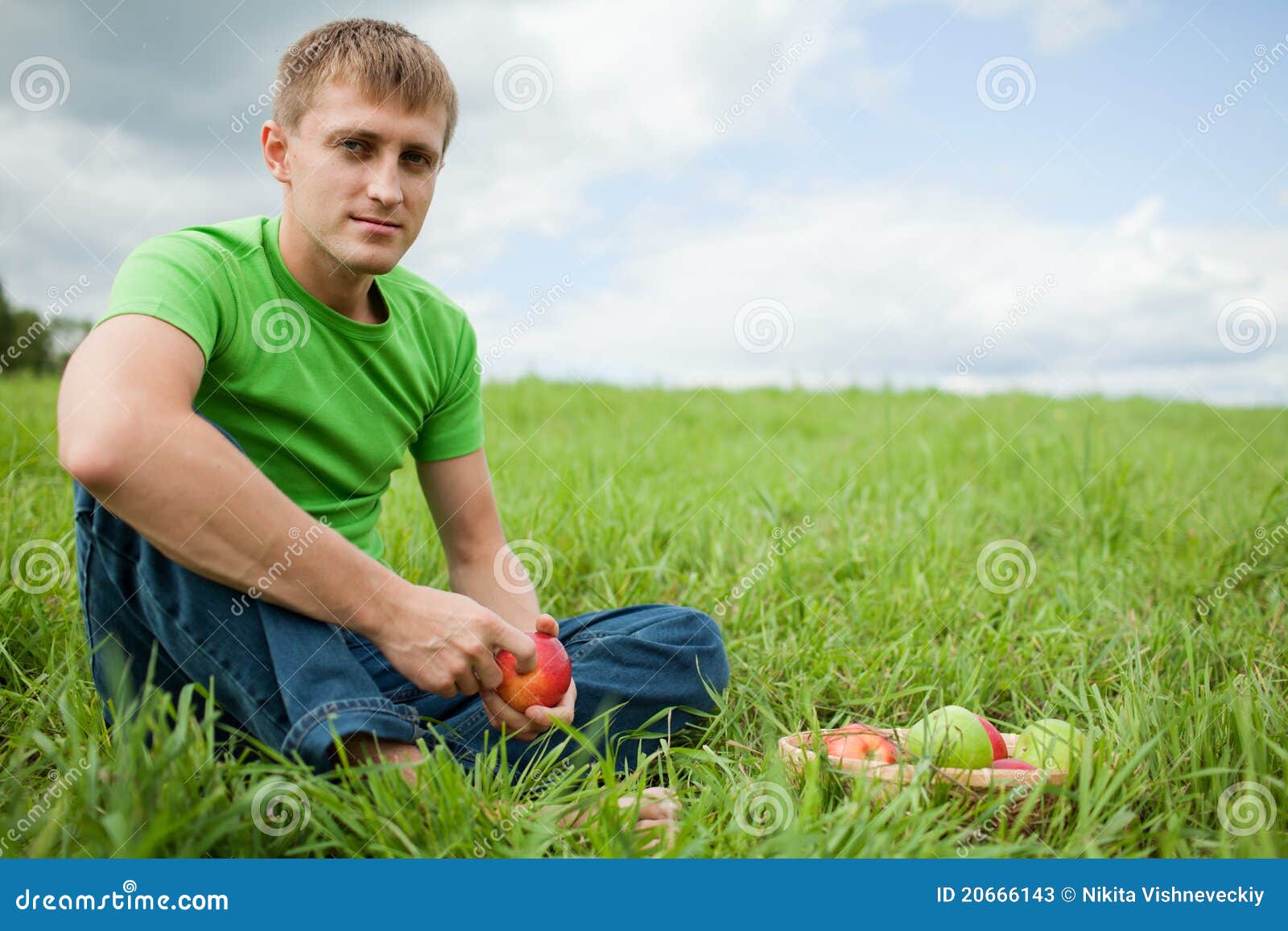 Young Man Sitting on the Grass with Apple Stock Image - Image of ...