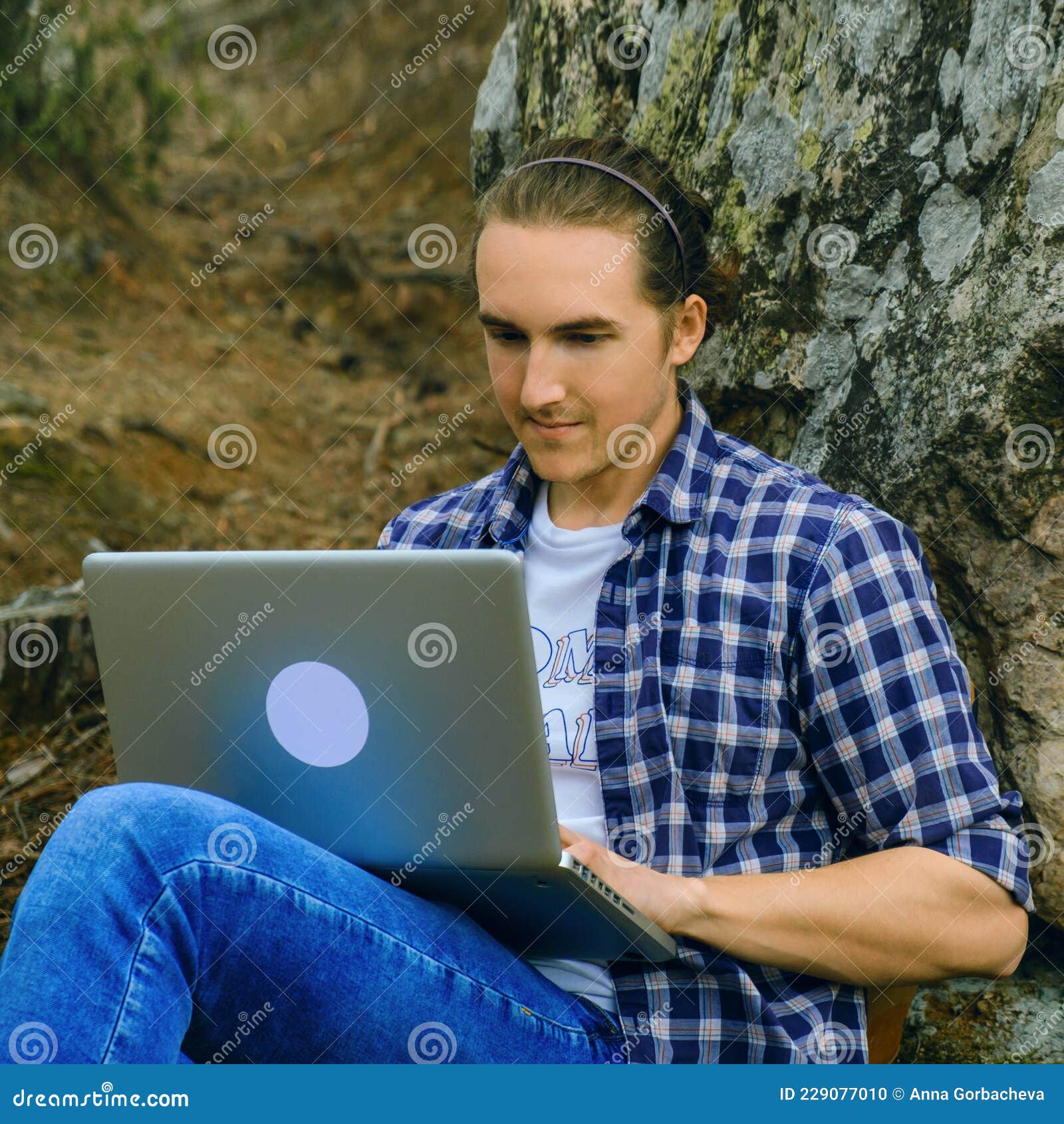 Man with laptop in forest. stock photo. Image of browsing - 229077010