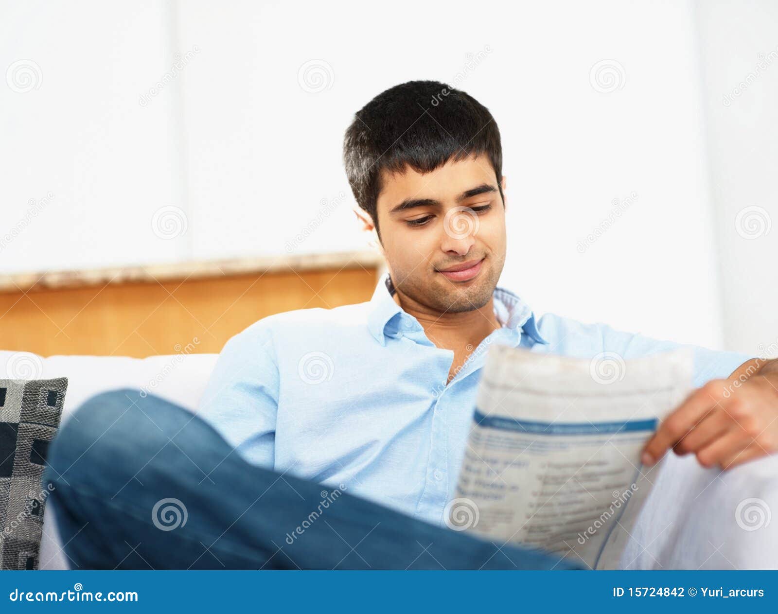 Young Man Sitting at Home Reading Newspaper Stock Photo - Image of life ...