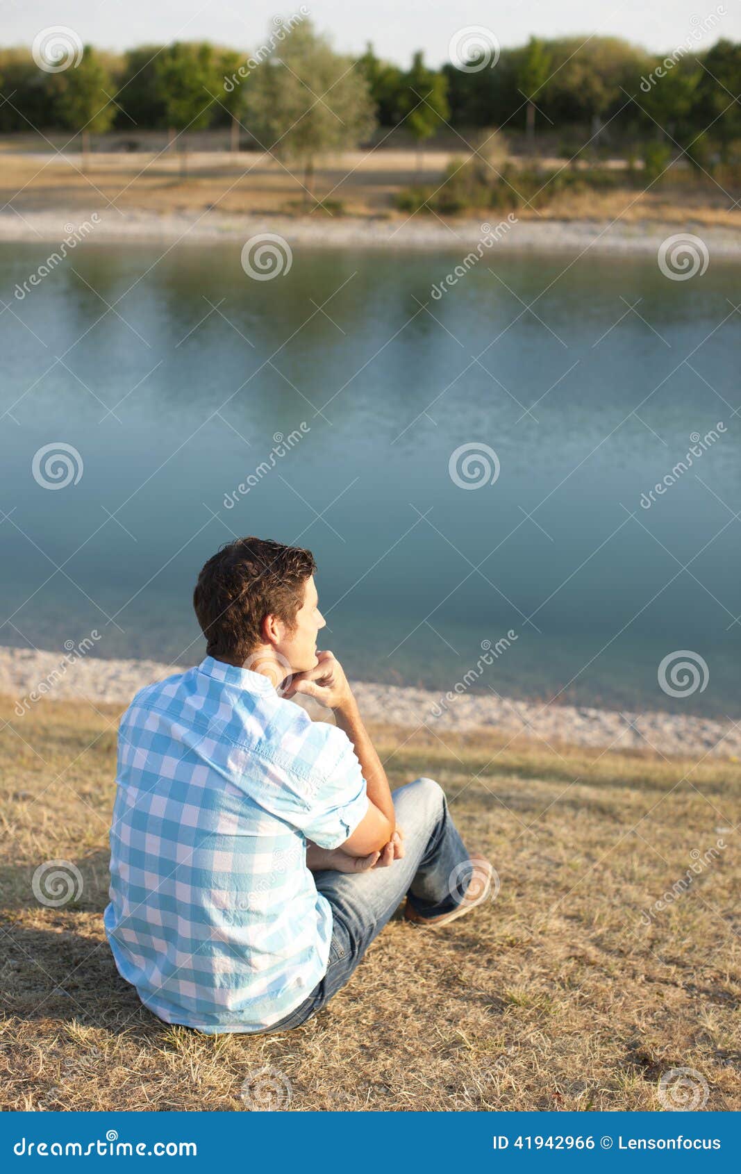 Young Man Sitting on the Lake Stock Photo - Image of think, calm: 41942966