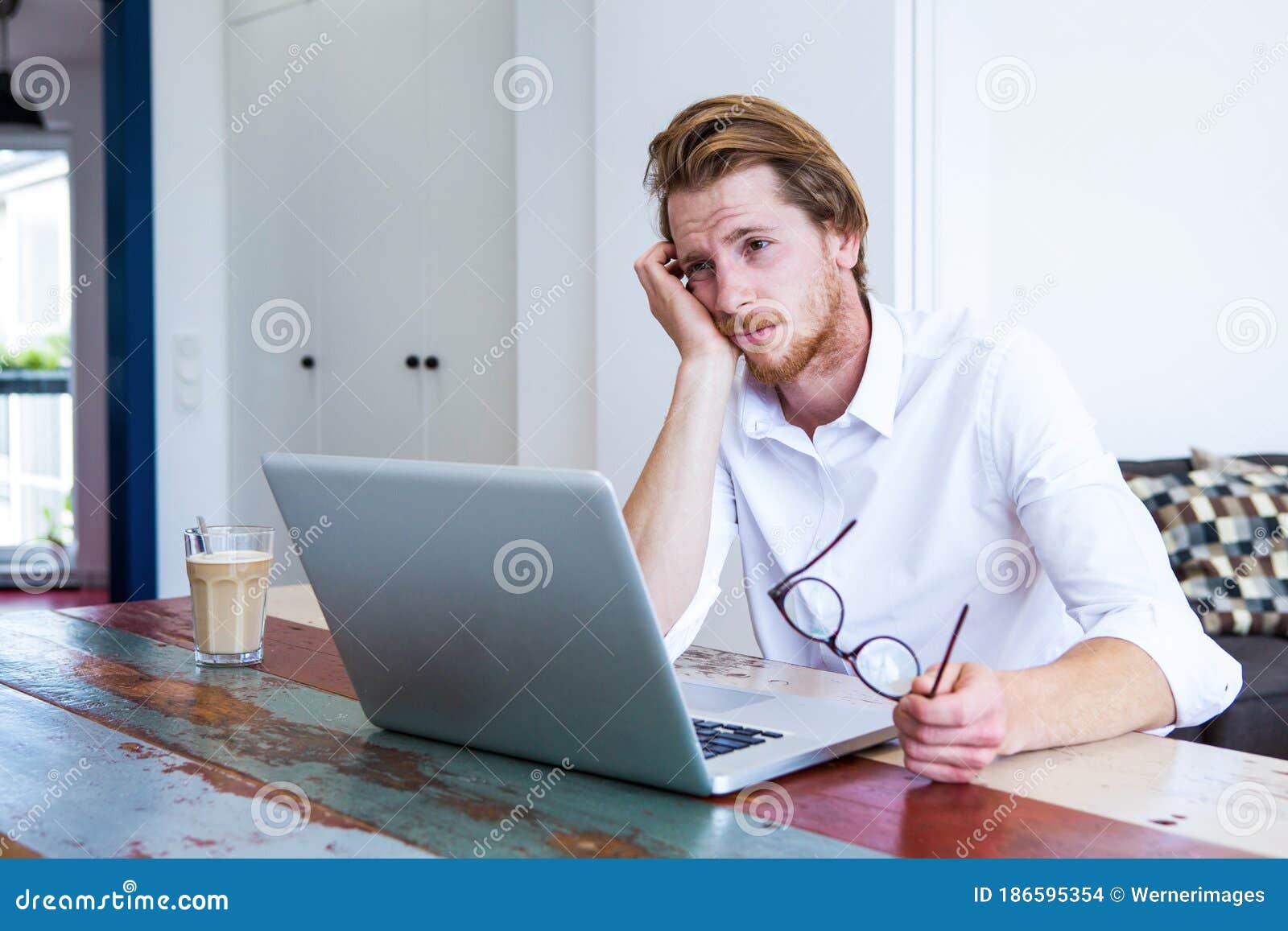 Young Man Sitting with Laptop and Looking Sad Stock Photo - Image of ...