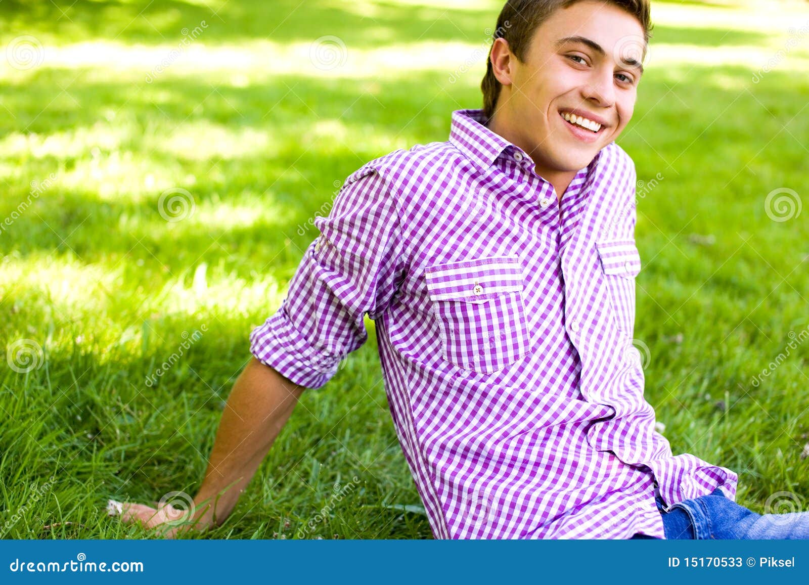 Young man sitting on lawn stock image. Image of lawn - 15170533