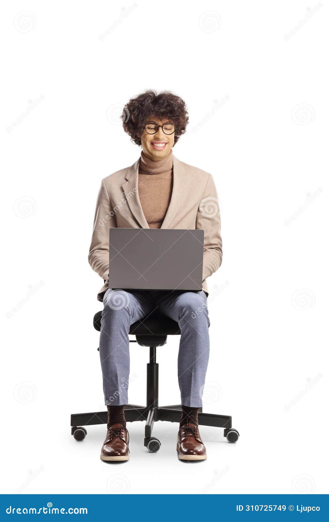 Young Man Sitting in an Office Chair and Working on a Laptop Computer ...