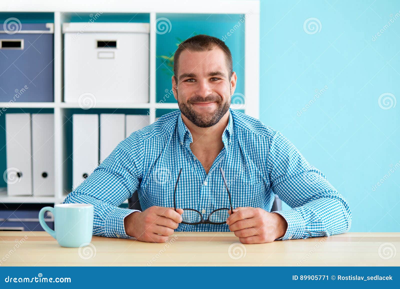 Young Man Sitting in Office Stock Image - Image of working ...