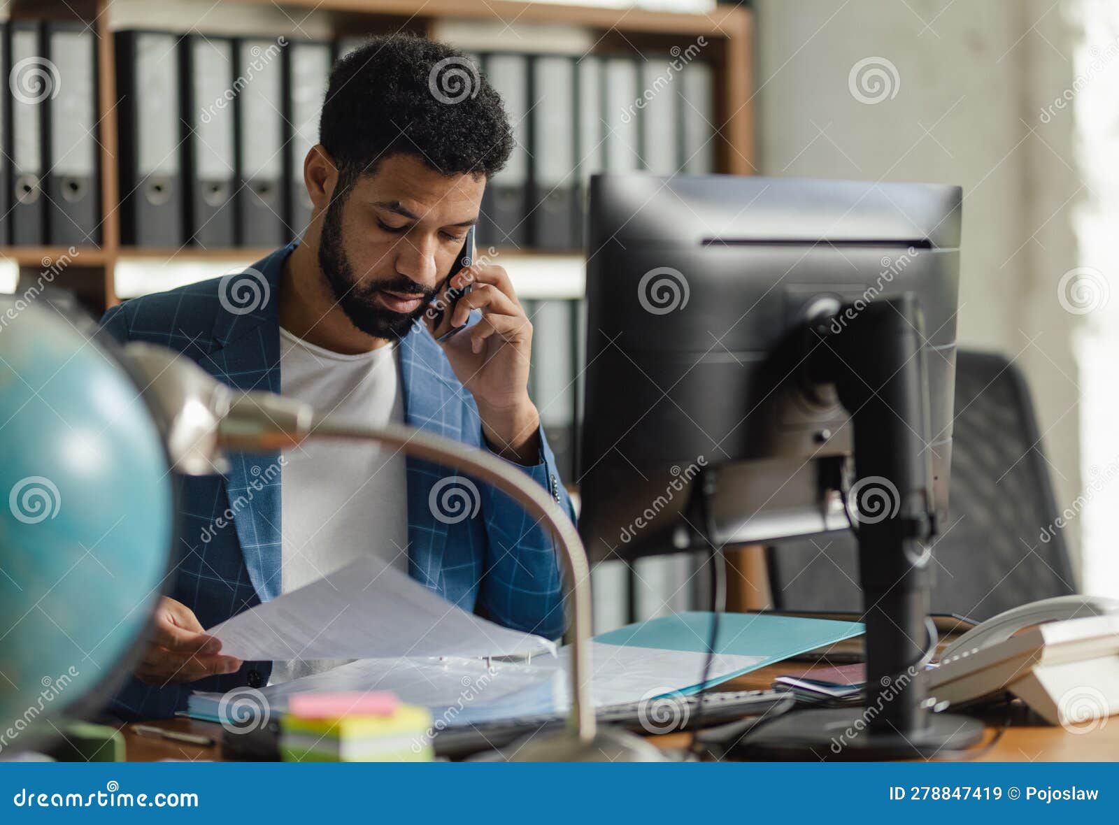 Young Man Sitting in Office and Working. Stock Image - Image of young ...