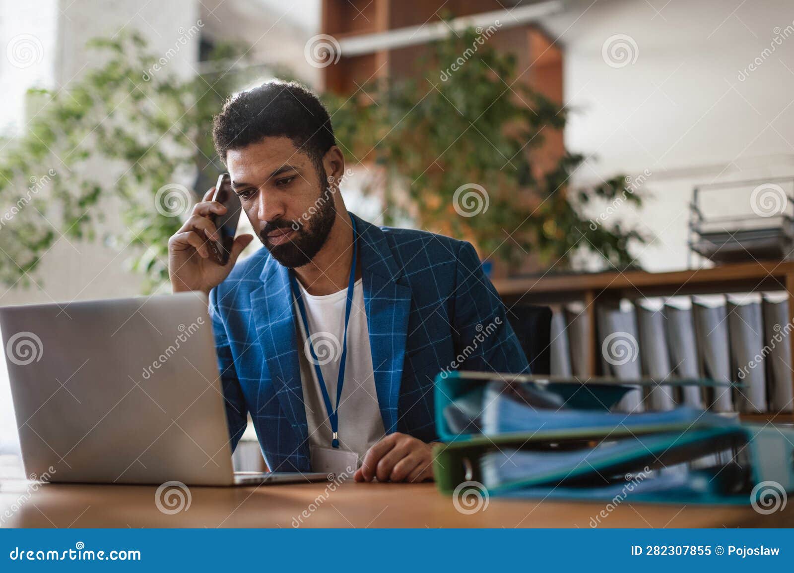 Young Man Sitting in Office and Working. Stock Image - Image of manager ...