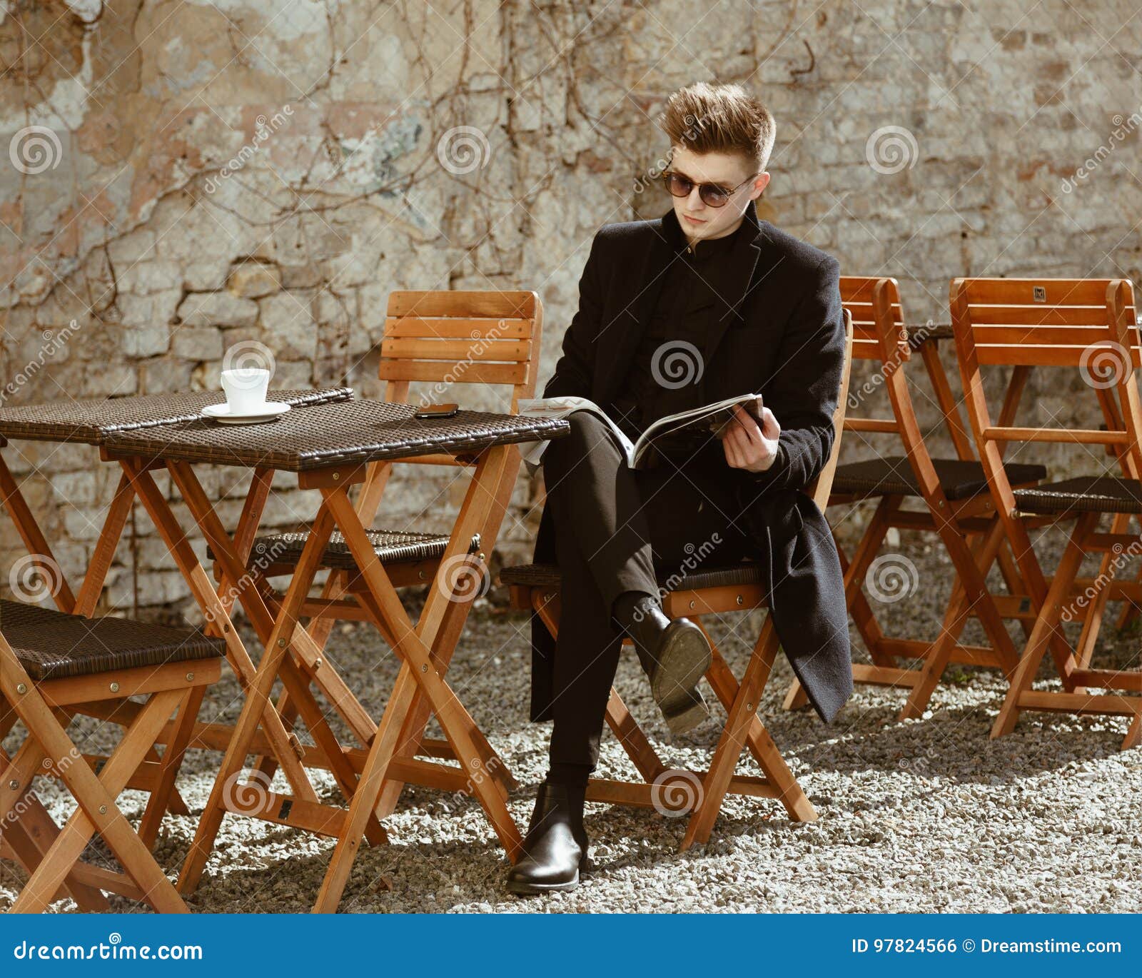 Young Man Sitting in Outdoor Cafe Stock Photo - Image of casual, phone ...