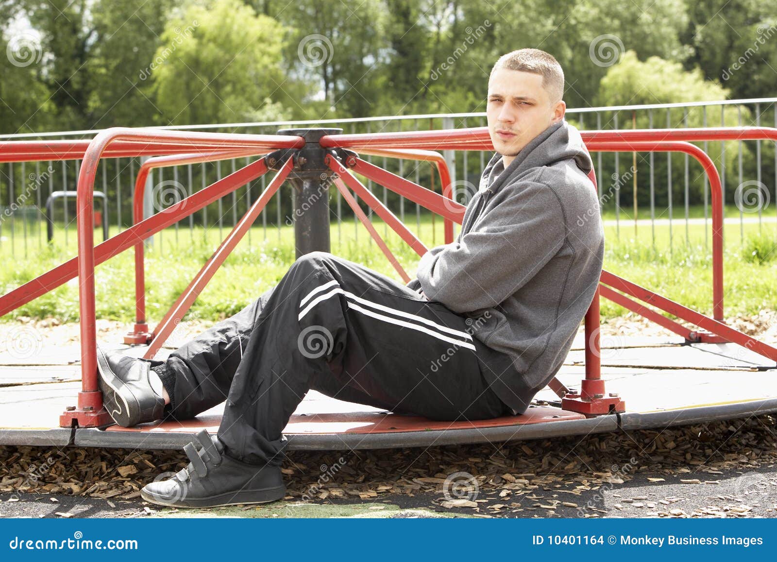 Young Man Sitting in Playground Stock Photo - Image of homeless, person ...