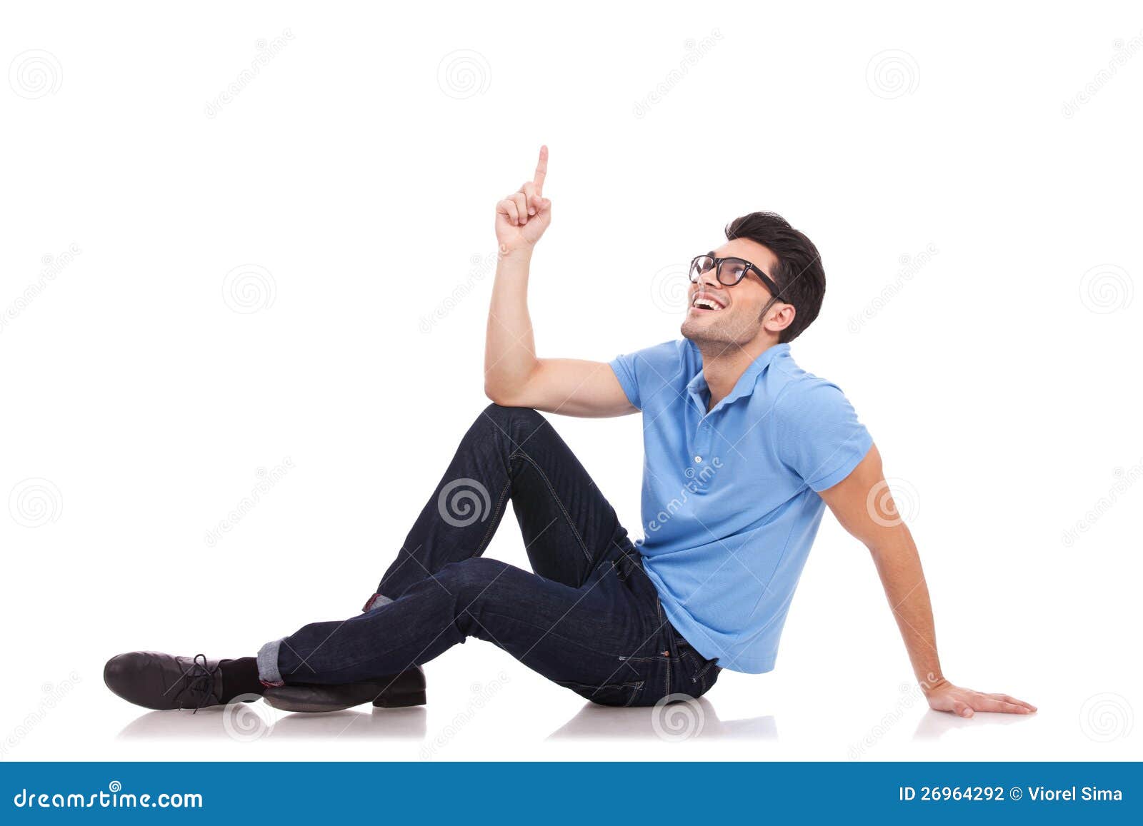Young Man Sitting and Pointing Upwards Stock Photo - Image of modern ...