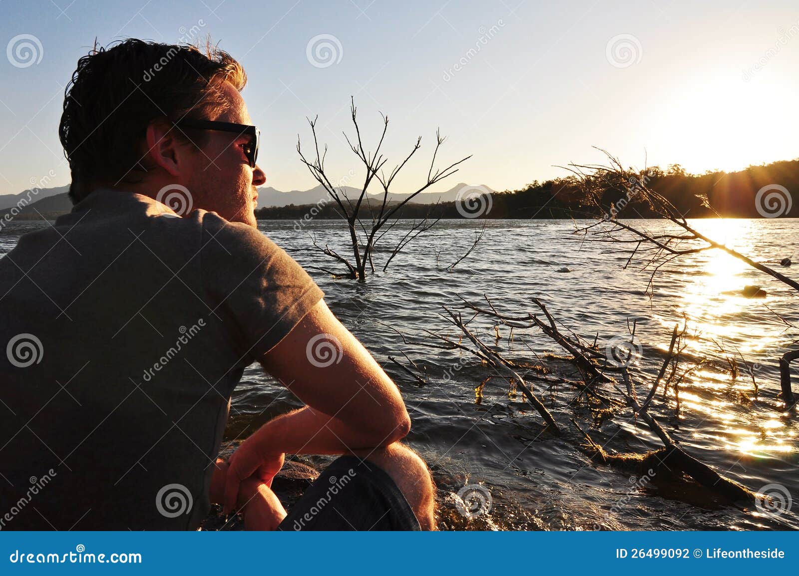 Young Man Sitting Quietly beside Lake Stock Photo - Image of lonely ...