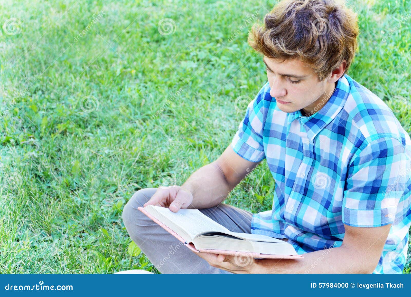 Young Man is Sitting and Reading a Book Stock Photo - Image of colors ...