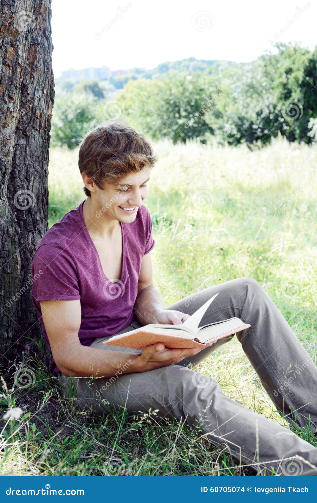 Young Man is Sitting and Reading a Book Stock Photo - Image of casual ...