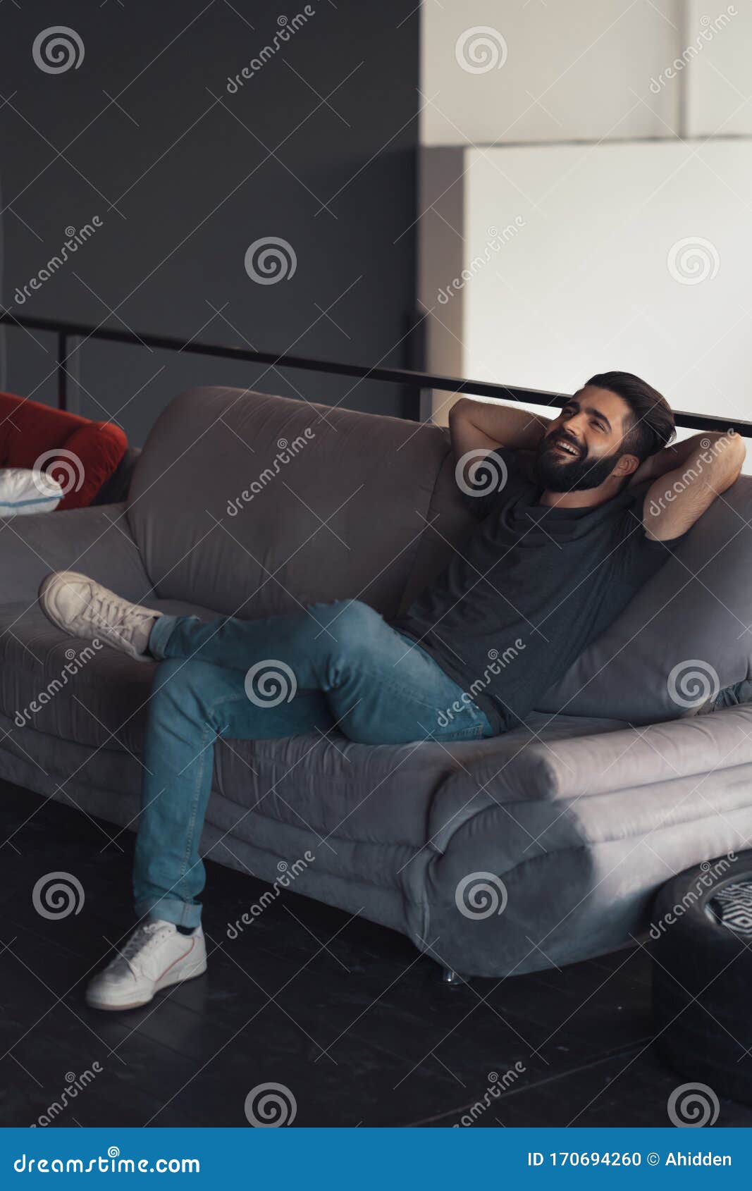 Young Man Sitting Relaxing on the Couch Stock Photo - Image of ...