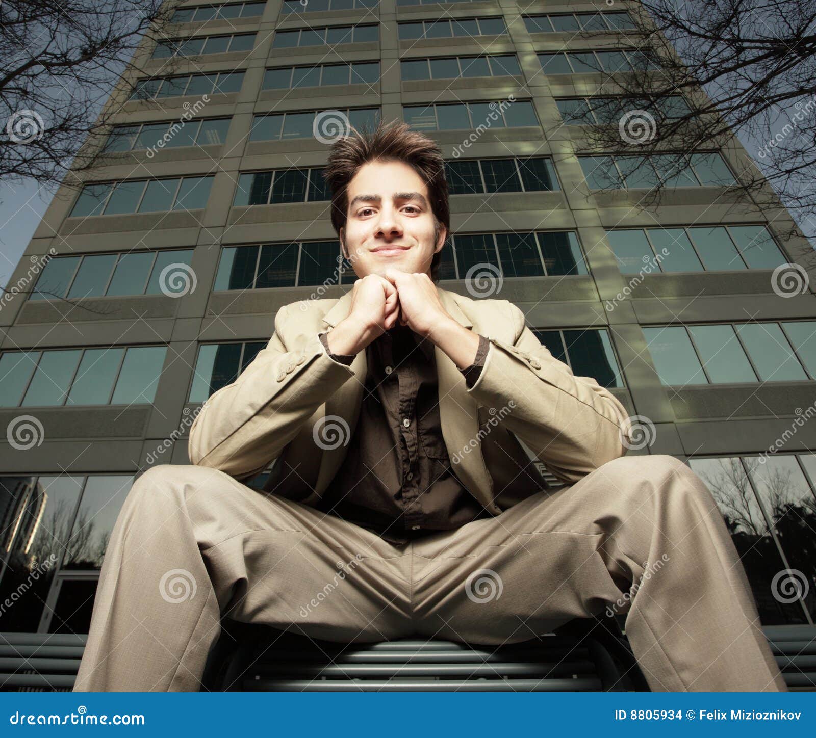 Young Man Sitting and Smiling Stock Photo - Image of male, jacket: 8805934