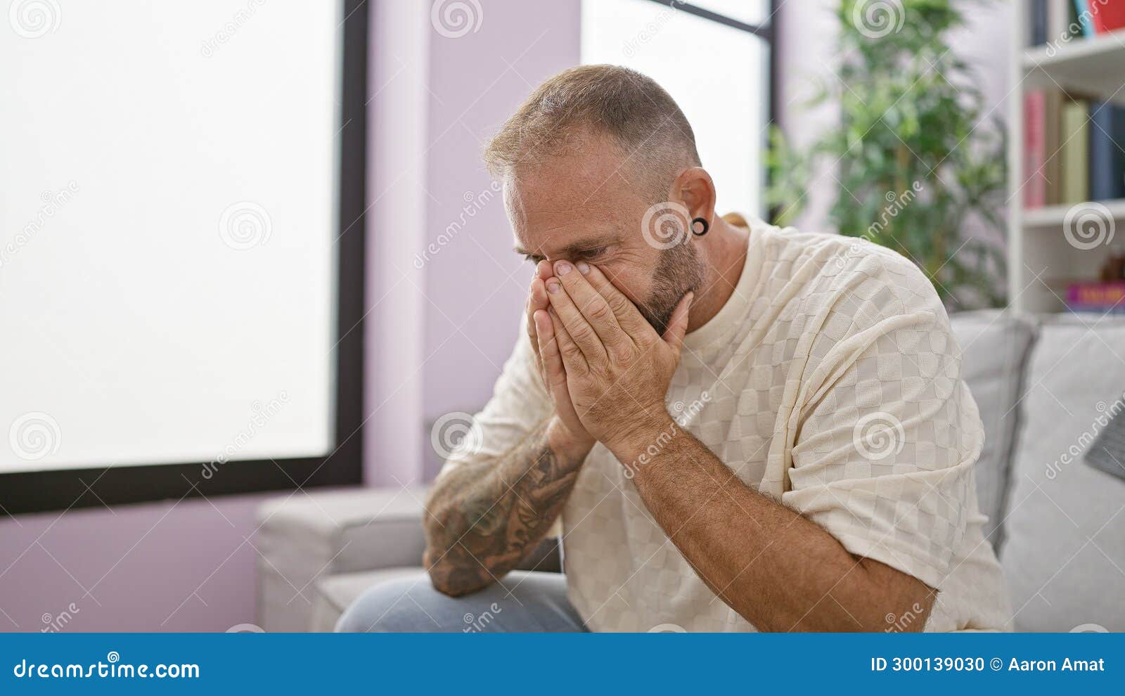 Young Man Sitting on Sofa Crying at Home Stock Photo - Image of sitting ...
