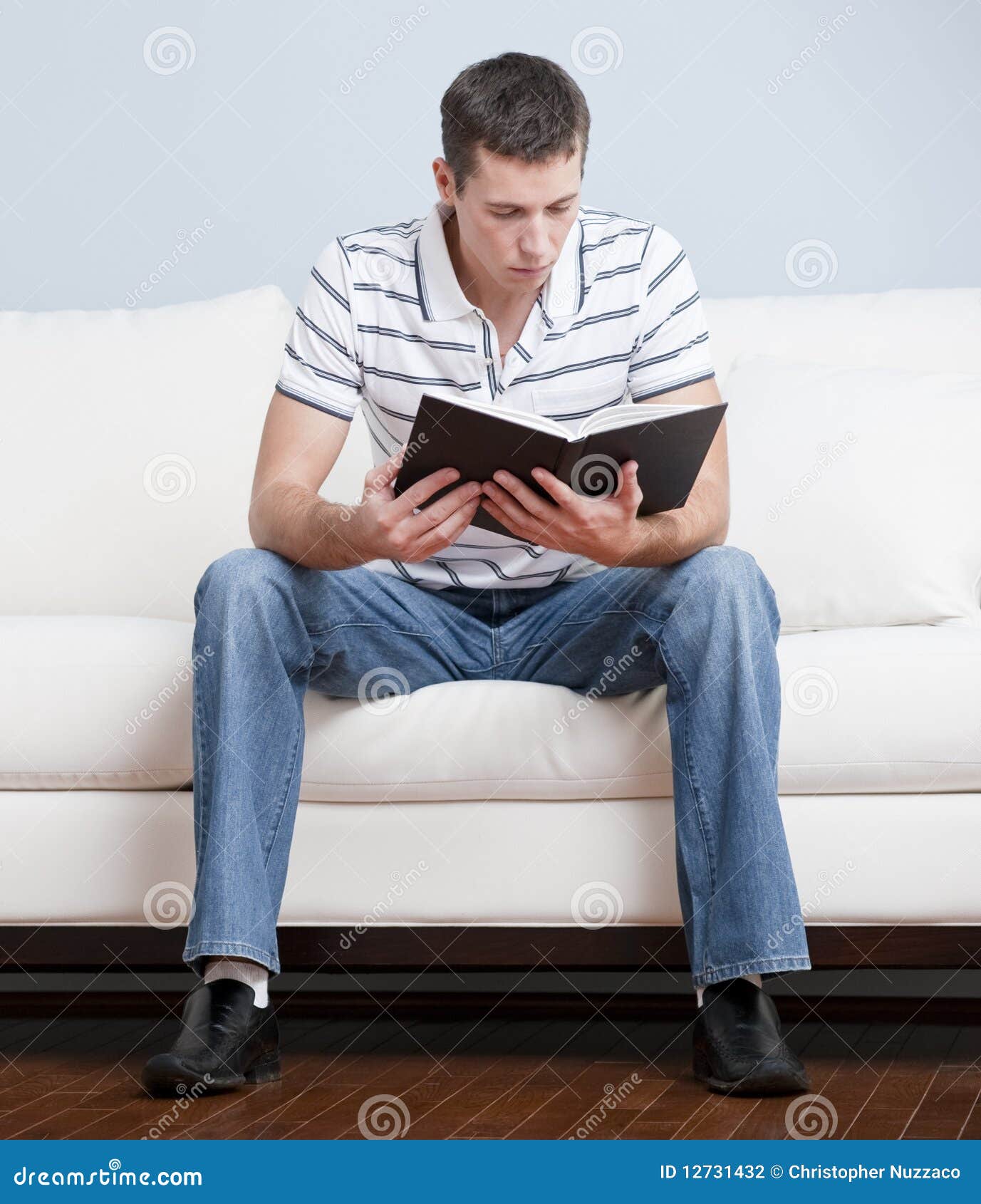 Young Man Sitting on Sofa Reading Stock Photo - Image of home, coffee ... Young Man Sitting on Sofa Reading Stock Photo - Image of home, coffee ...