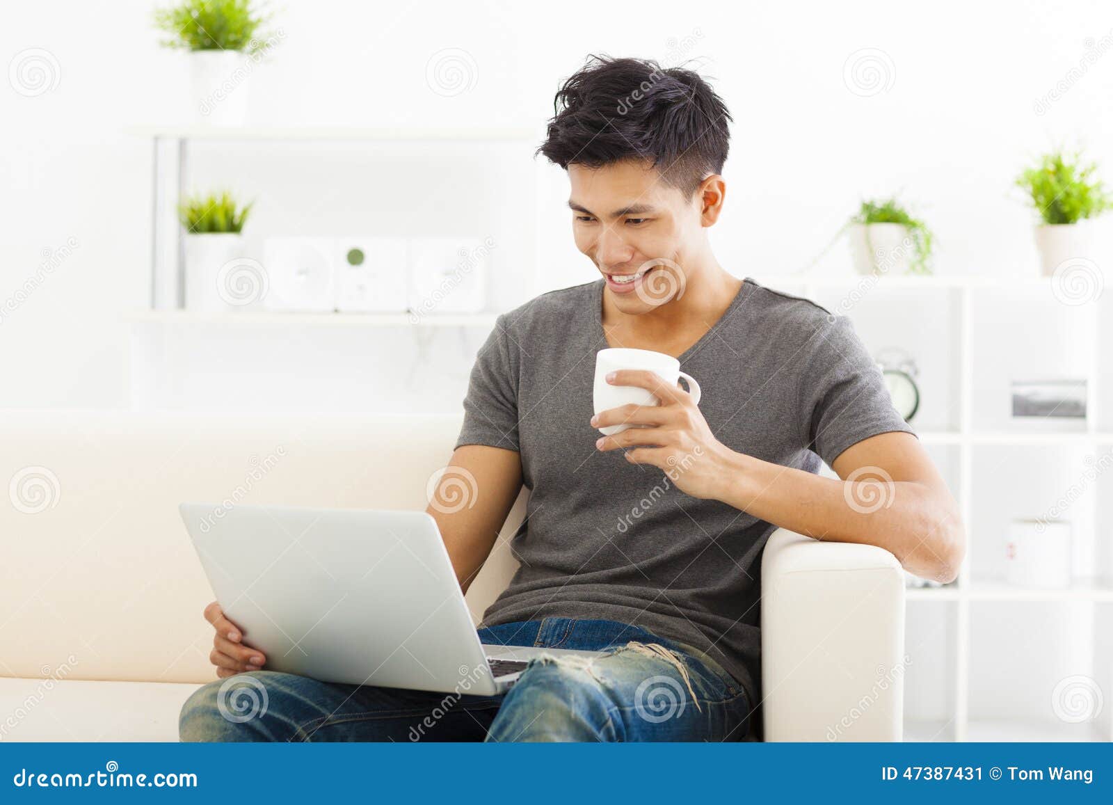 Young Man Sitting in Sofa and Using Laptop Stock Image - Image of asian ...