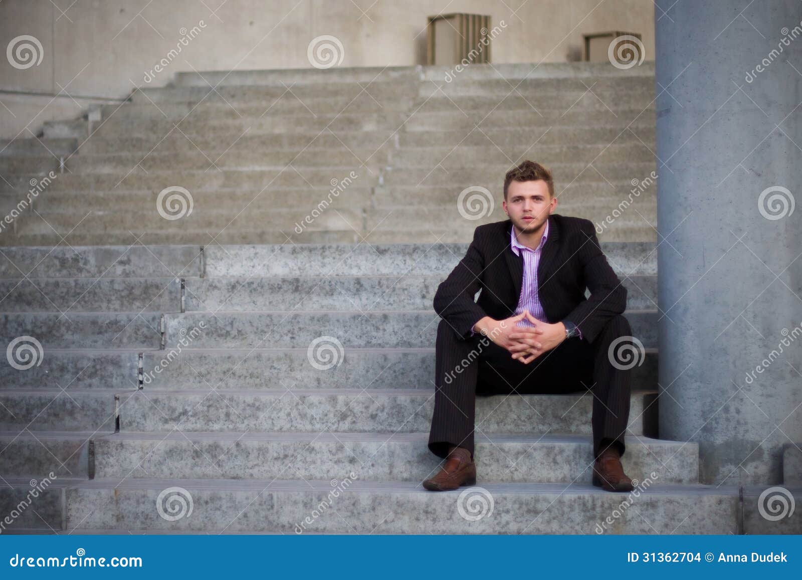 Young Man Sitting on Stairs Stock Photo - Image of hair, building: 31362704