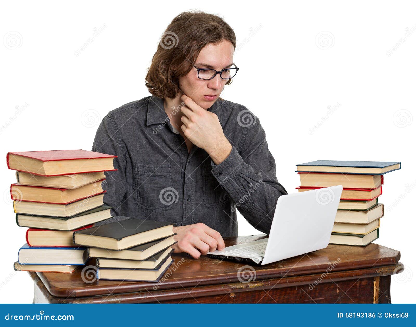 Young Man Sitting at a Table with Books and Laptop Stock Photo - Image ...