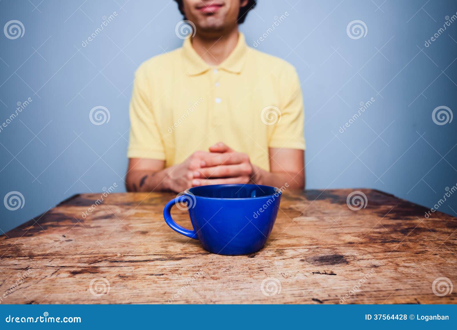 Young Man Sitting at Table with Cup of Coffee Stock Photo - Image of ...
