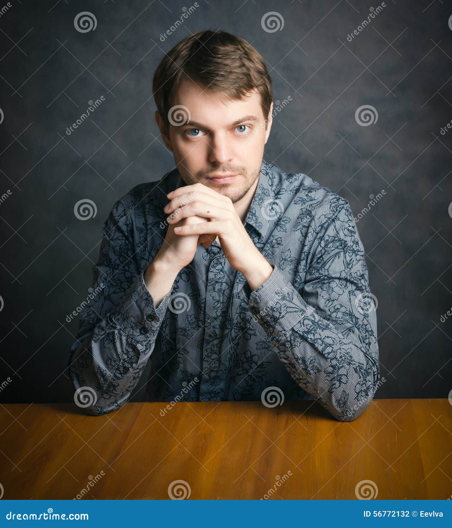 Young Man Sitting at a Table. Stock Photo - Image of mysterious, grey ...