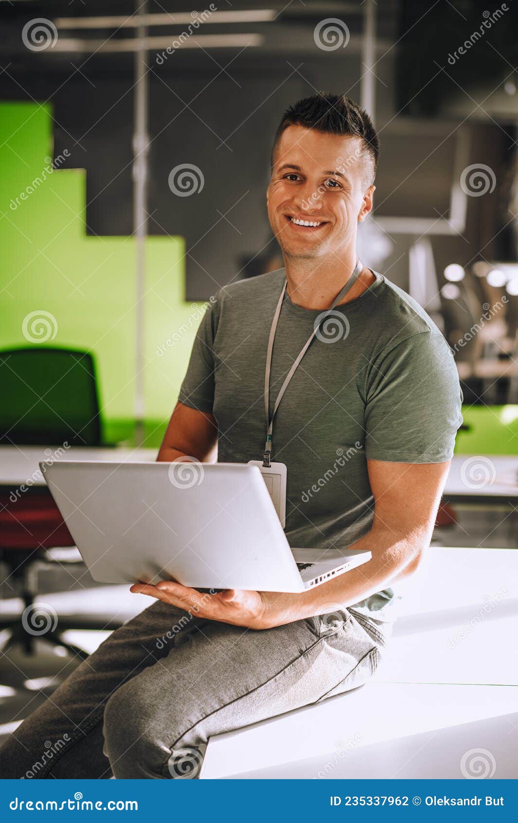 Young Man Sitting on the Table with a Laptop Stock Photo - Image of ...