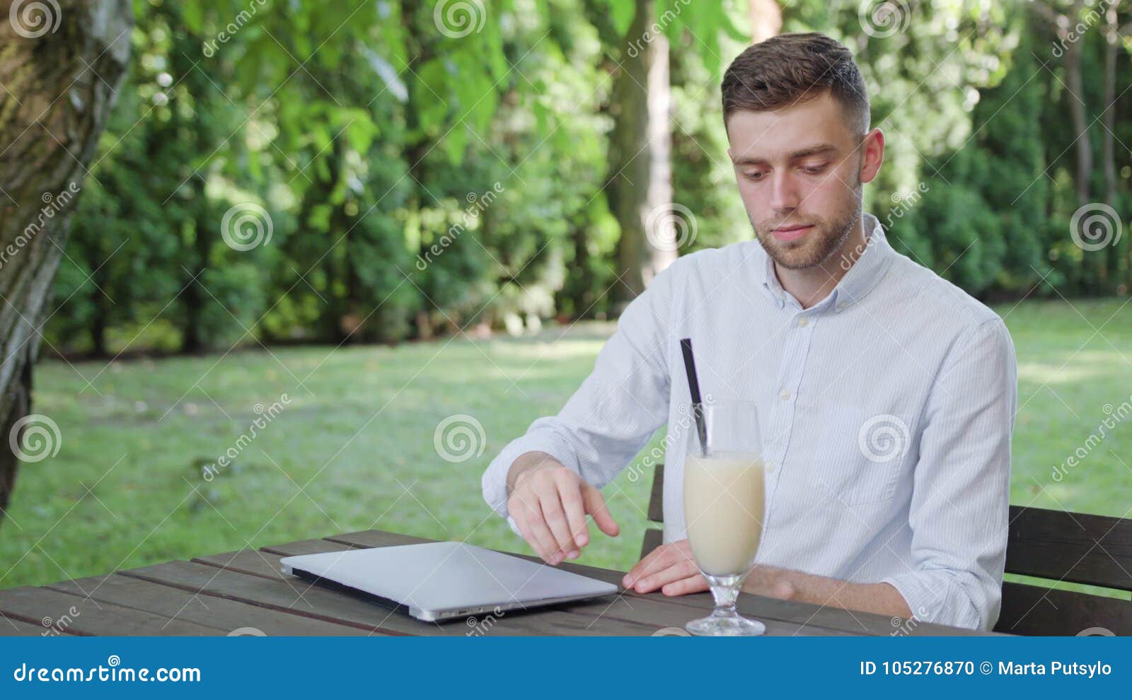 A Young Man Drinking Milkshake in the Park Stock Photo - Image of ...