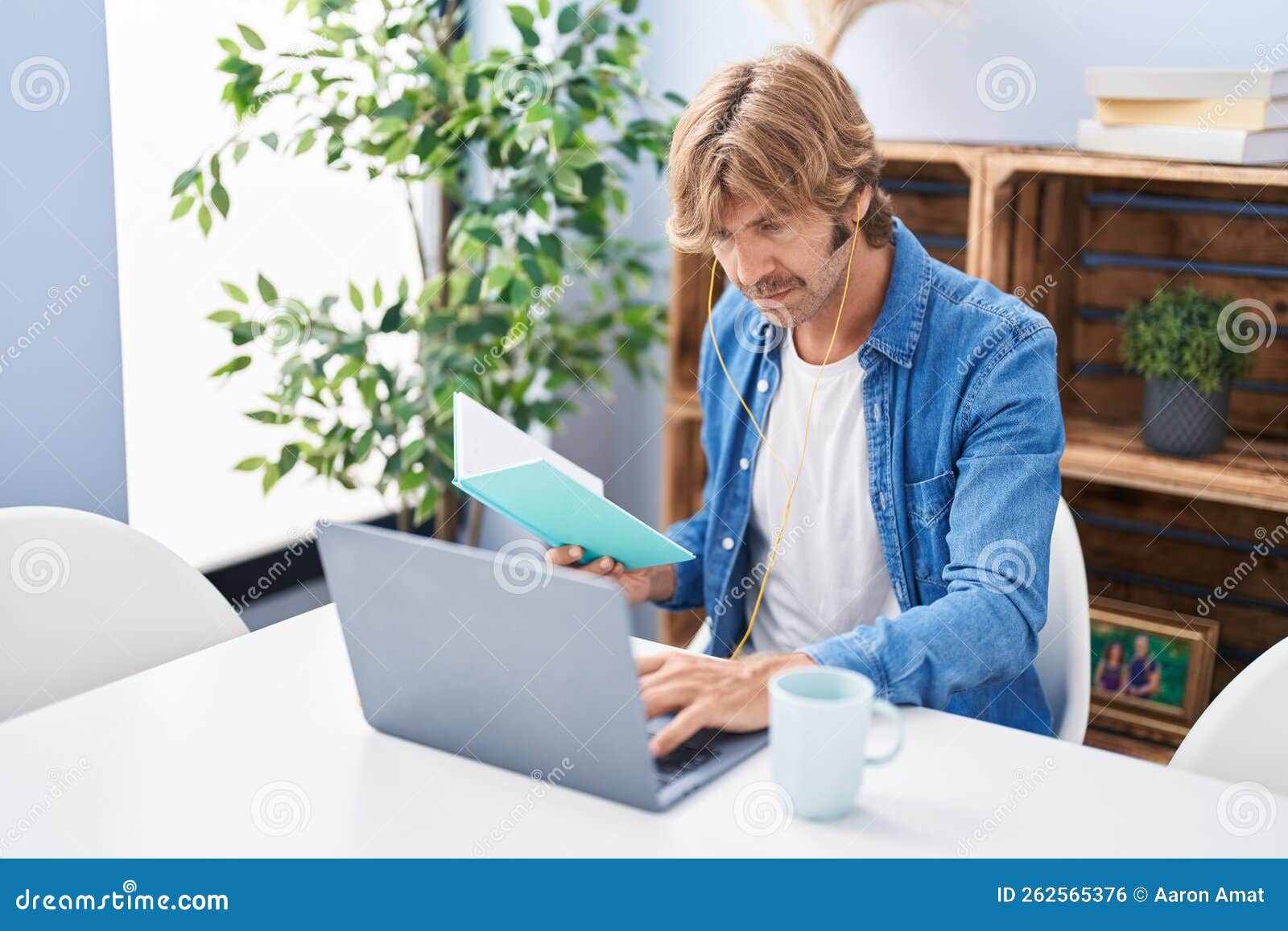 Young Man Sitting on Table Studying at Home Stock Photo - Image of ...