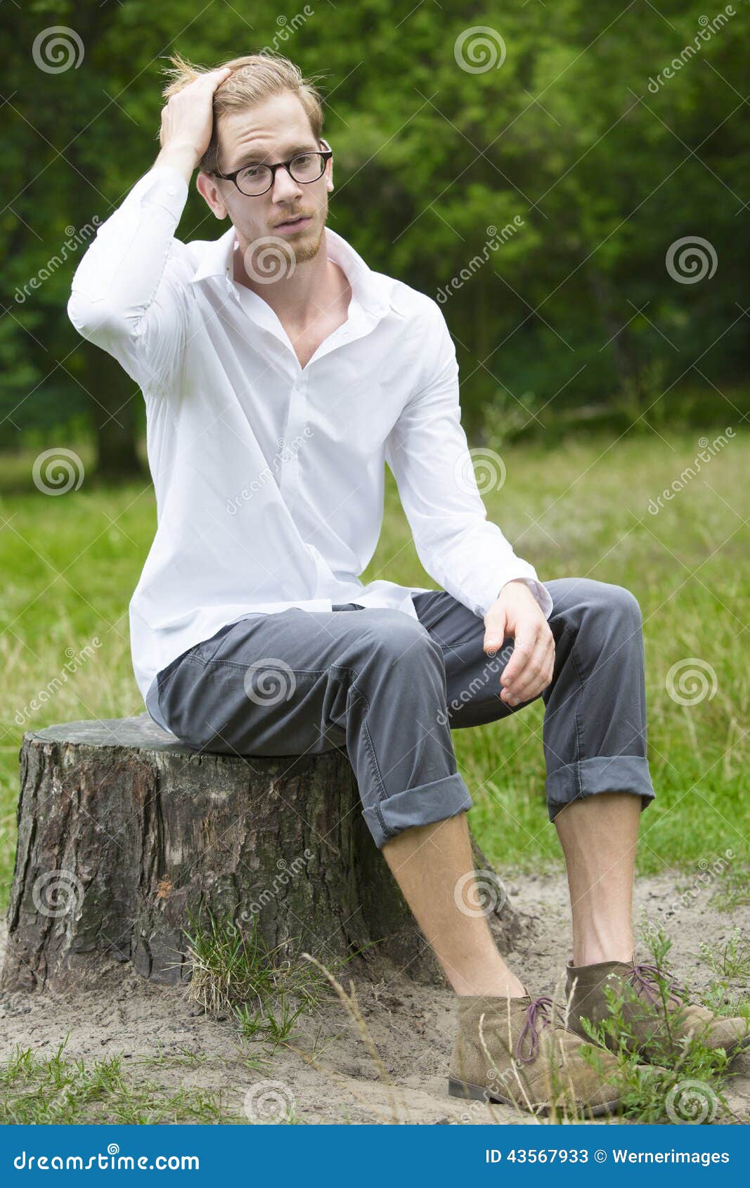 Young Man Sitting on a Tree Stump Stock Image - Image of green ...