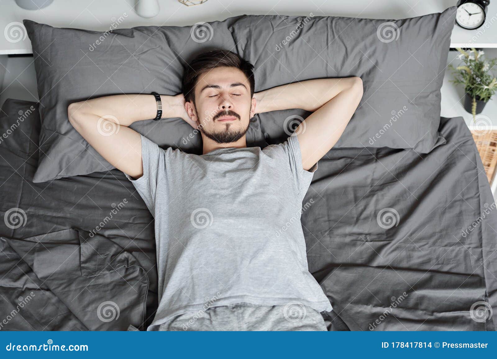 Young man sleeping in bed stock photo. Image of resting - 178417814
