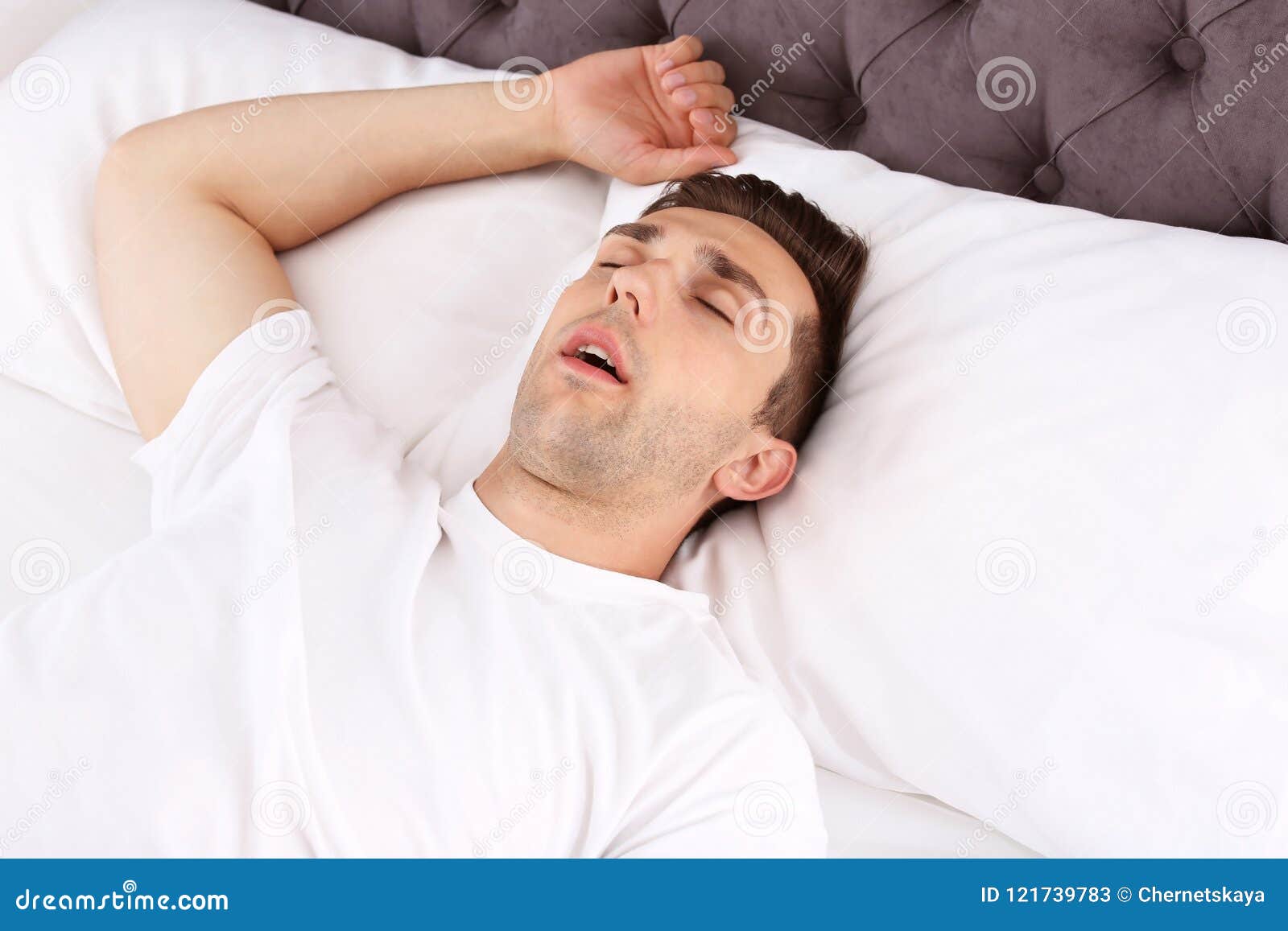 Young man sleeping in bed stock image. Image of male - 121739783