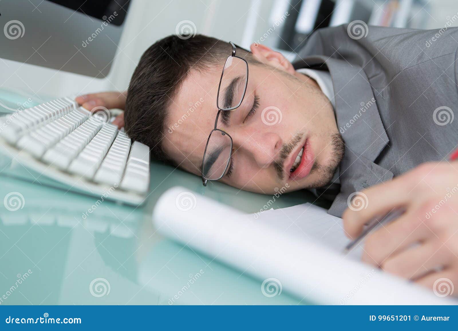 Young man sleeping at desk stock image. Image of tired - 99651201